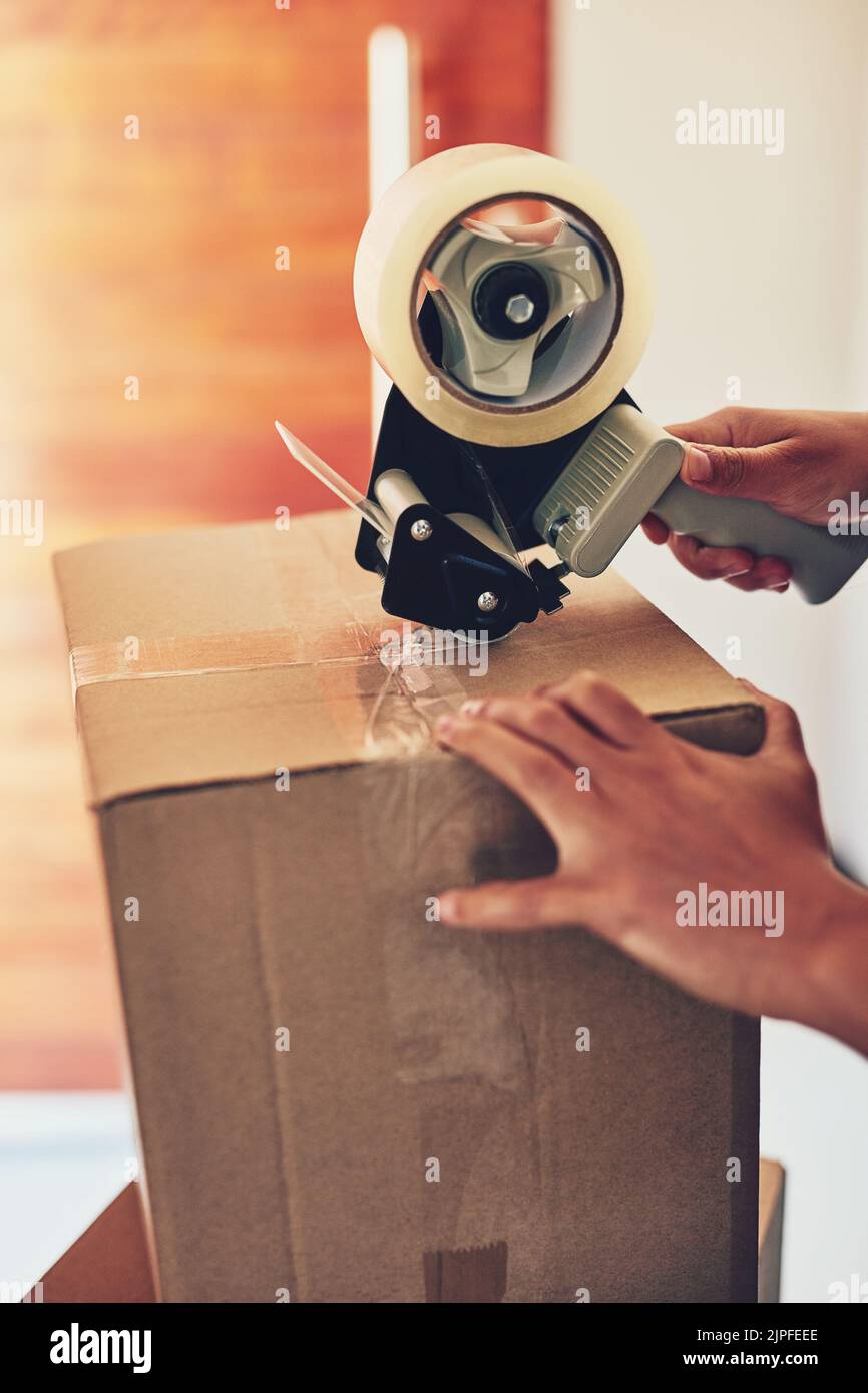 Getting it all boxed up. Closeup shot of an unidentifiable woman using ...