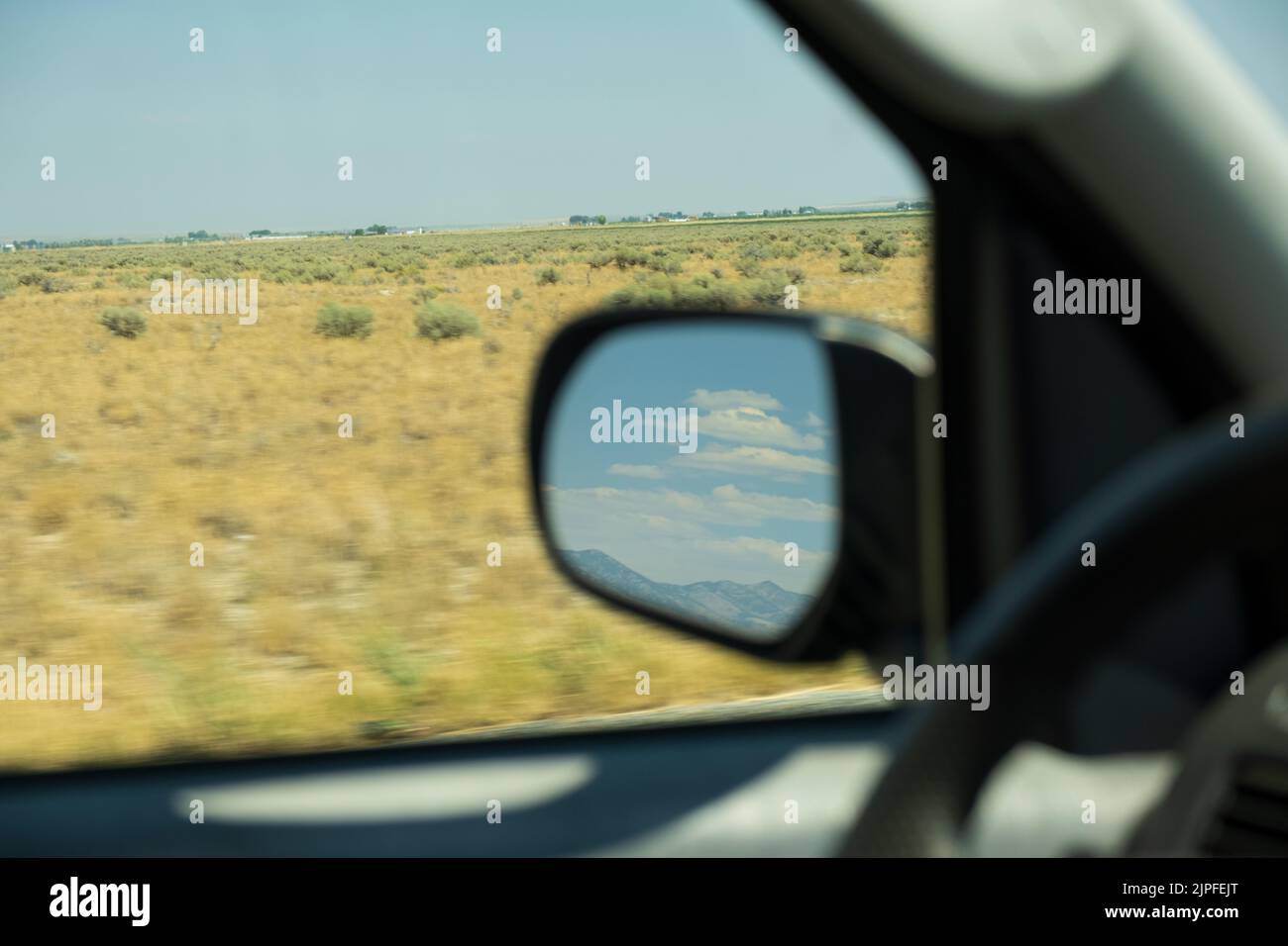 Clouds in side mirror of car driving in desert Stock Photo - Alamy