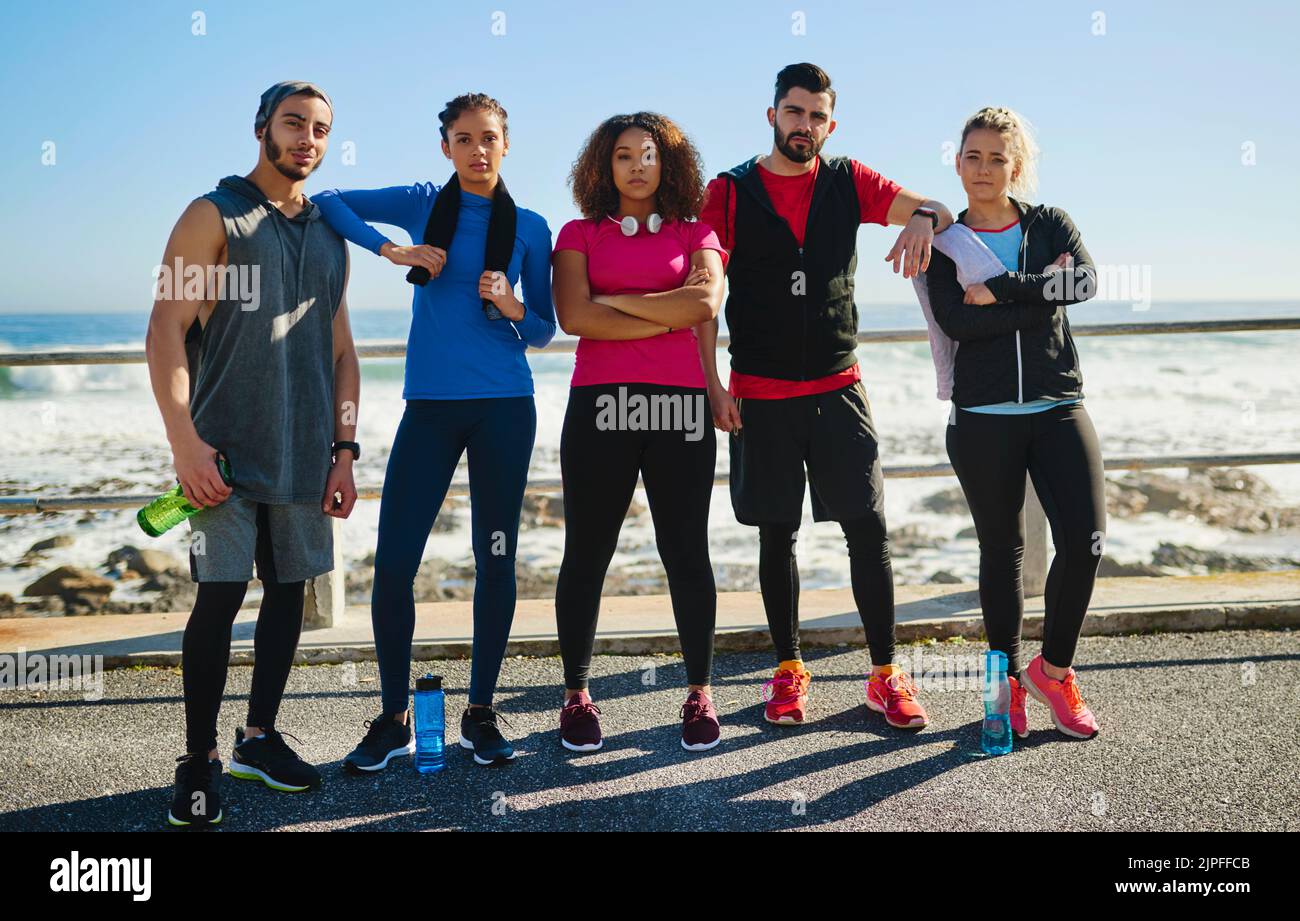 One mean team. Portrait of a cheerful young group of friends standing ...