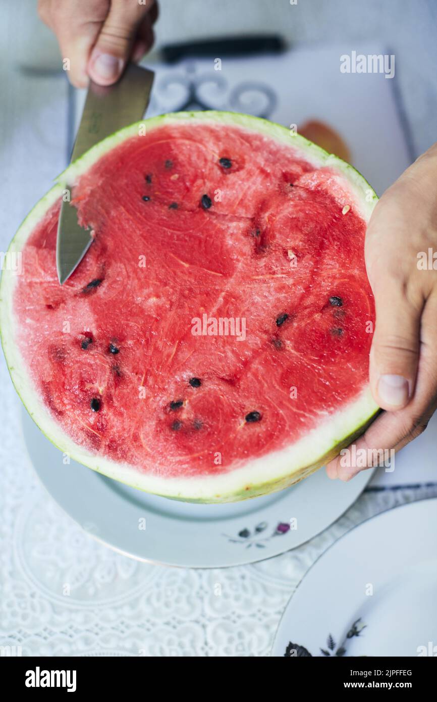 Juicy red watermelon is cut with a knife. The concept of summer and ...