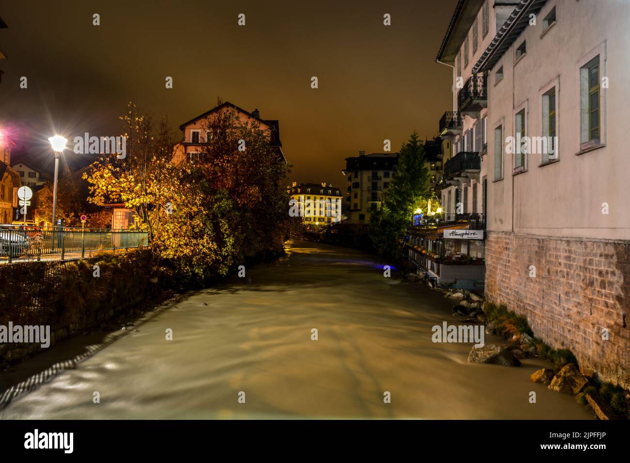 The river flowing downstream in the town of Chamonix, France at night ...