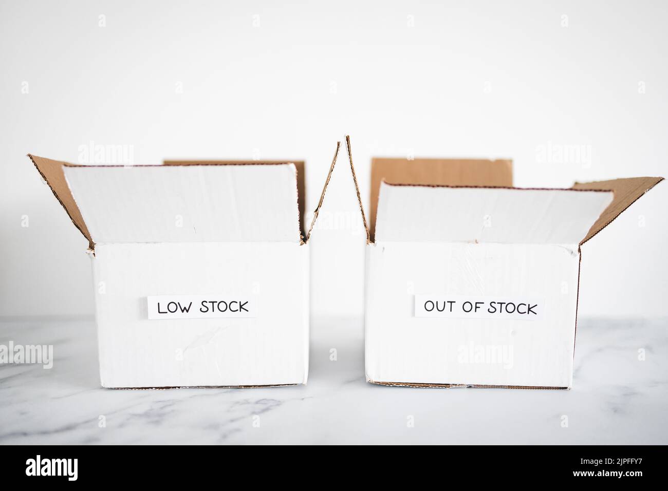 Low stock and out of stock texts on white delivery parcels on white ...