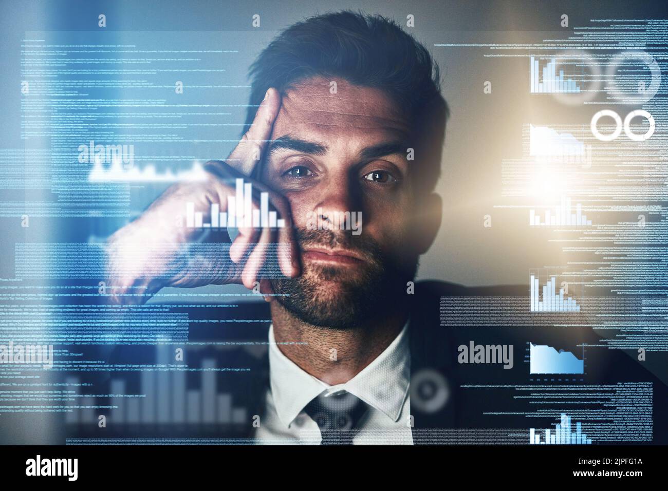 This code bores me. Cropped portrait of a young businessman looking bored coding late in the ...