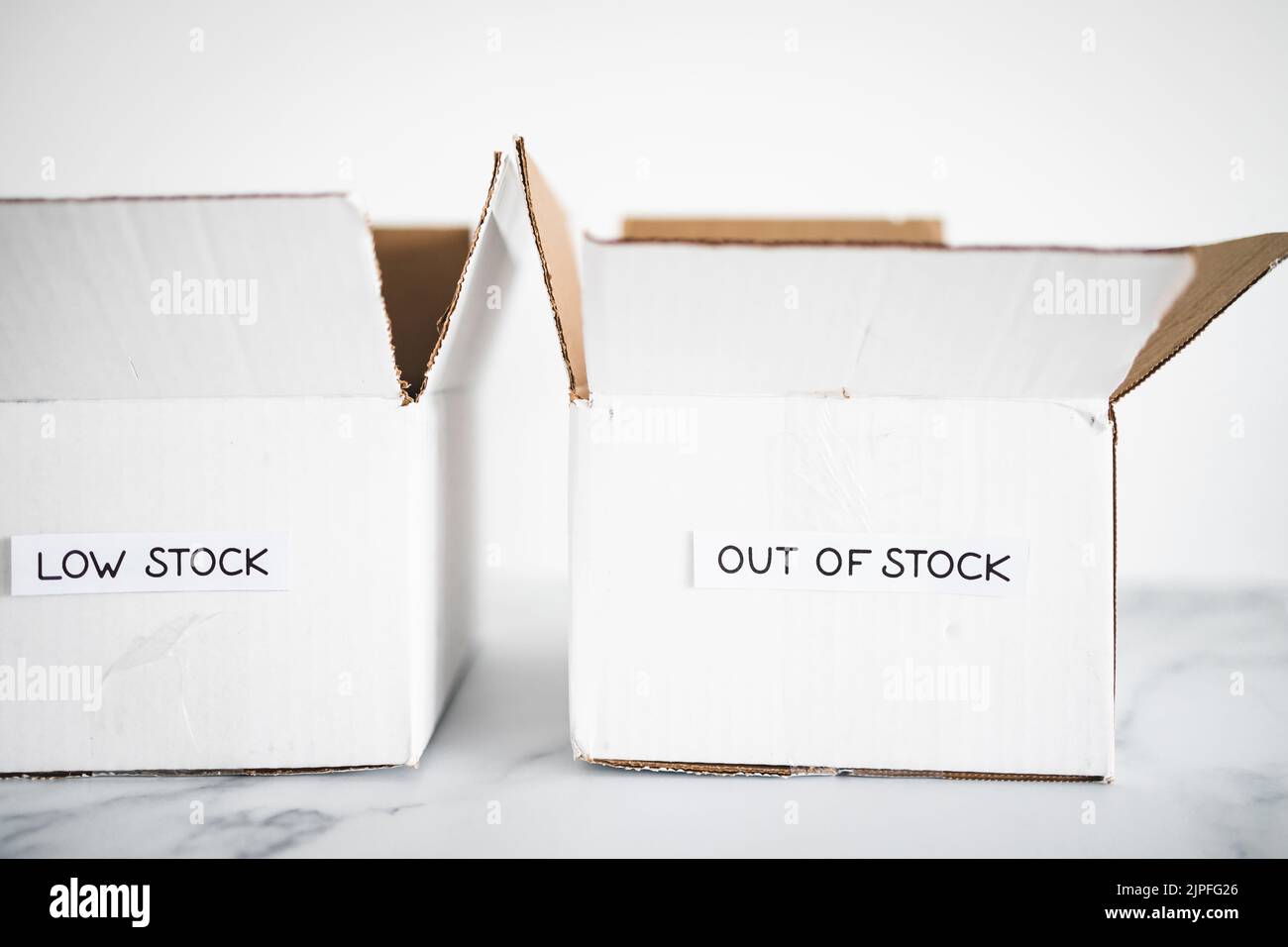 Low stock and out of stock texts on white delivery parcels on white ...