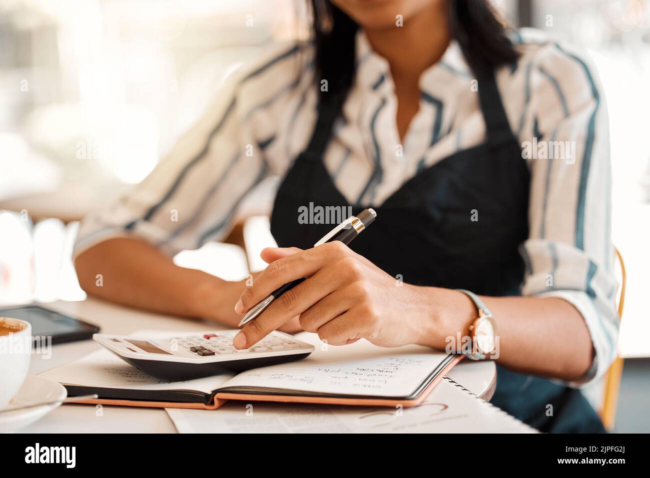 Hands of business owner taking orders, calculating profit and working ...