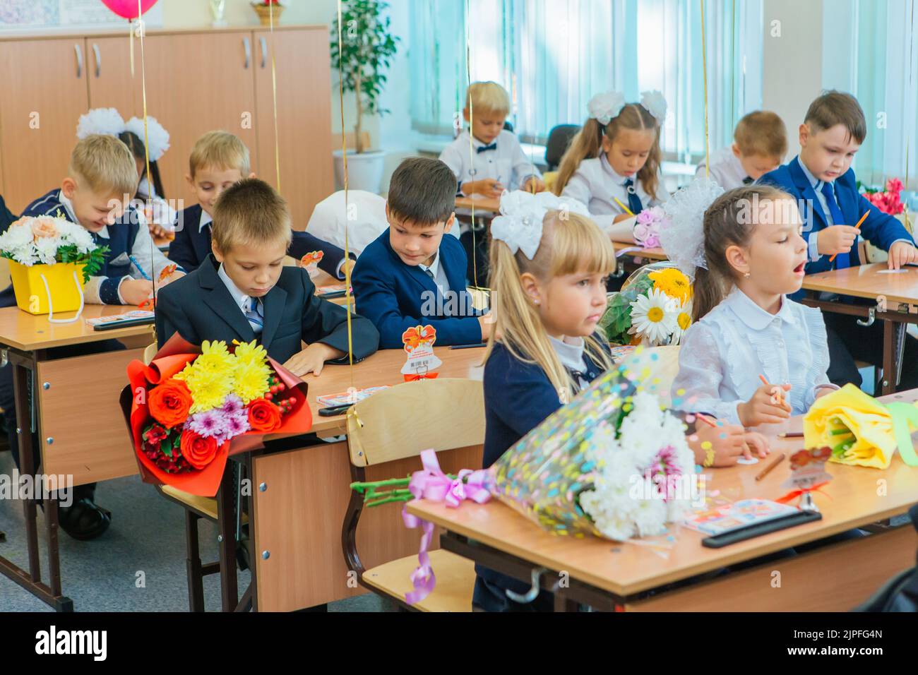 First-grade students and teacher are in school classroom at first ...