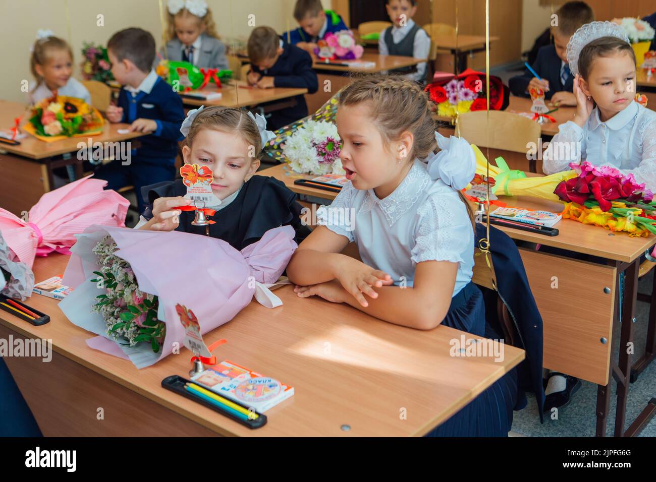 First-grade students and teacher are in school classroom at first ...
