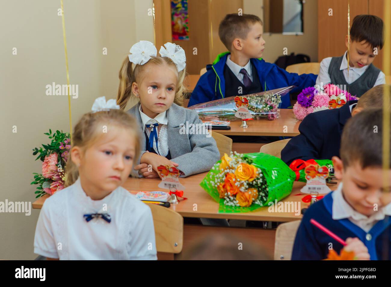 First-grade students and teacher are in school classroom at first ...