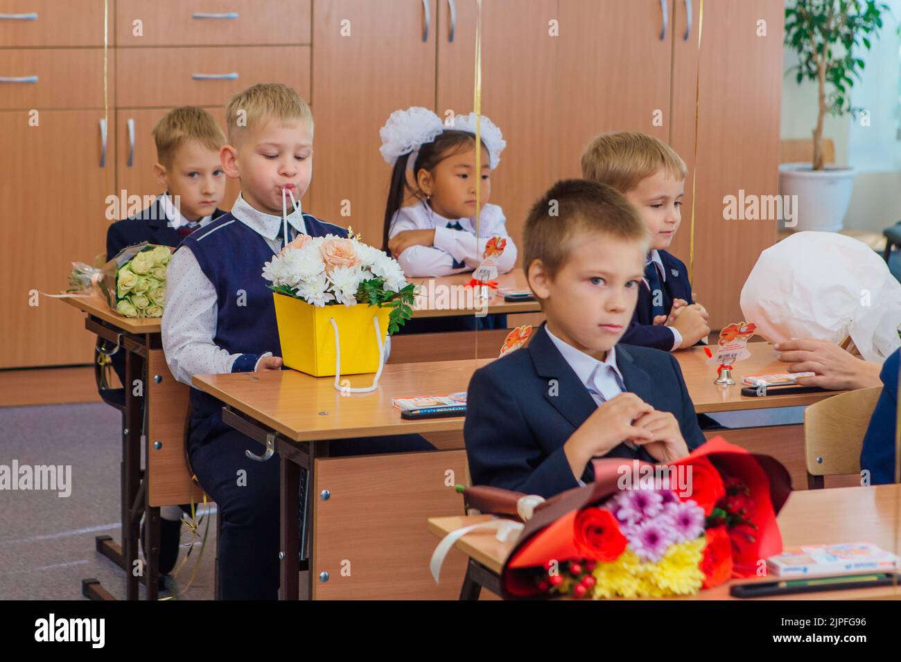 First-grade students and teacher are in school classroom at first ...