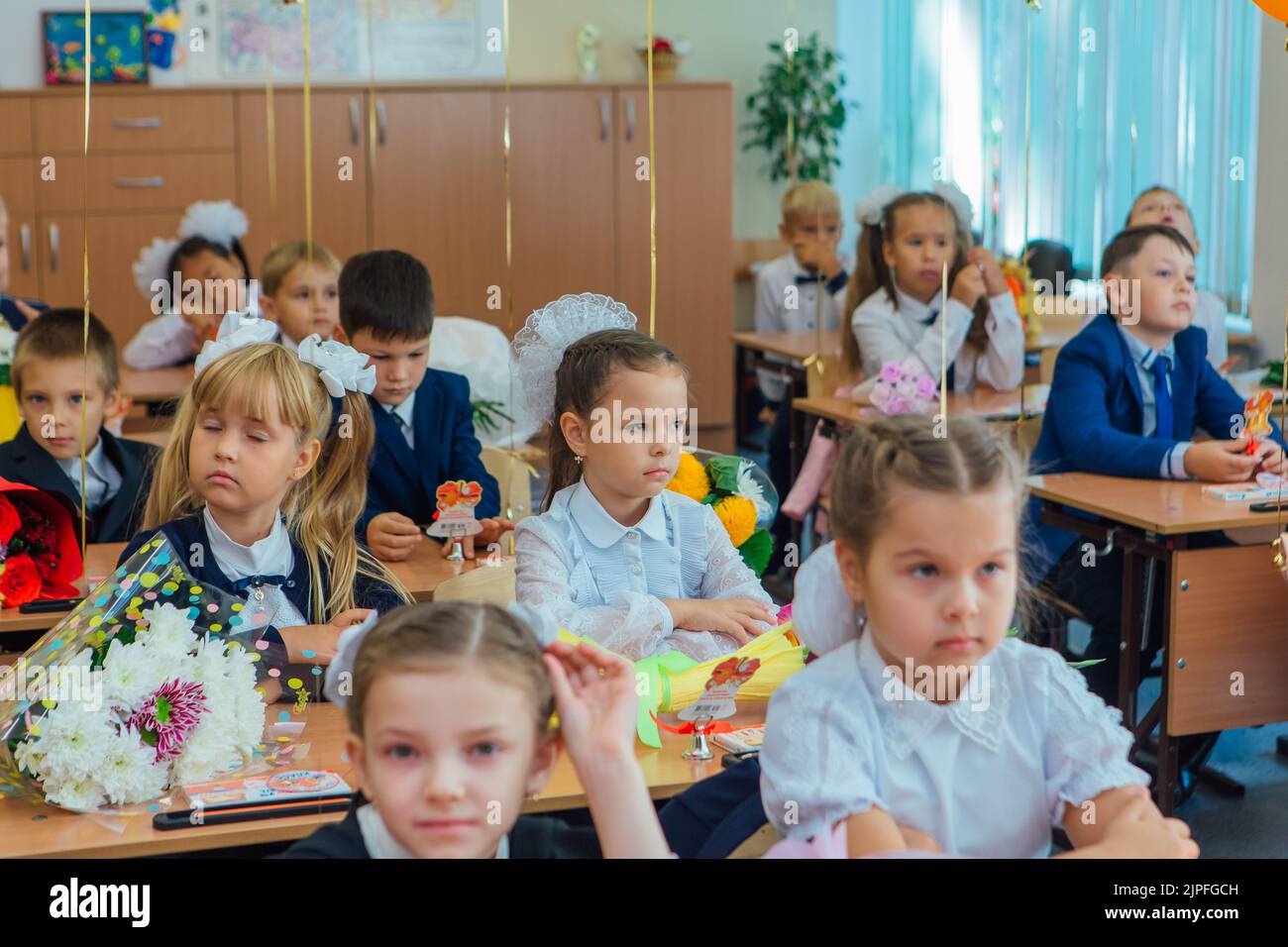 First-grade students and teacher are in school classroom at first ...
