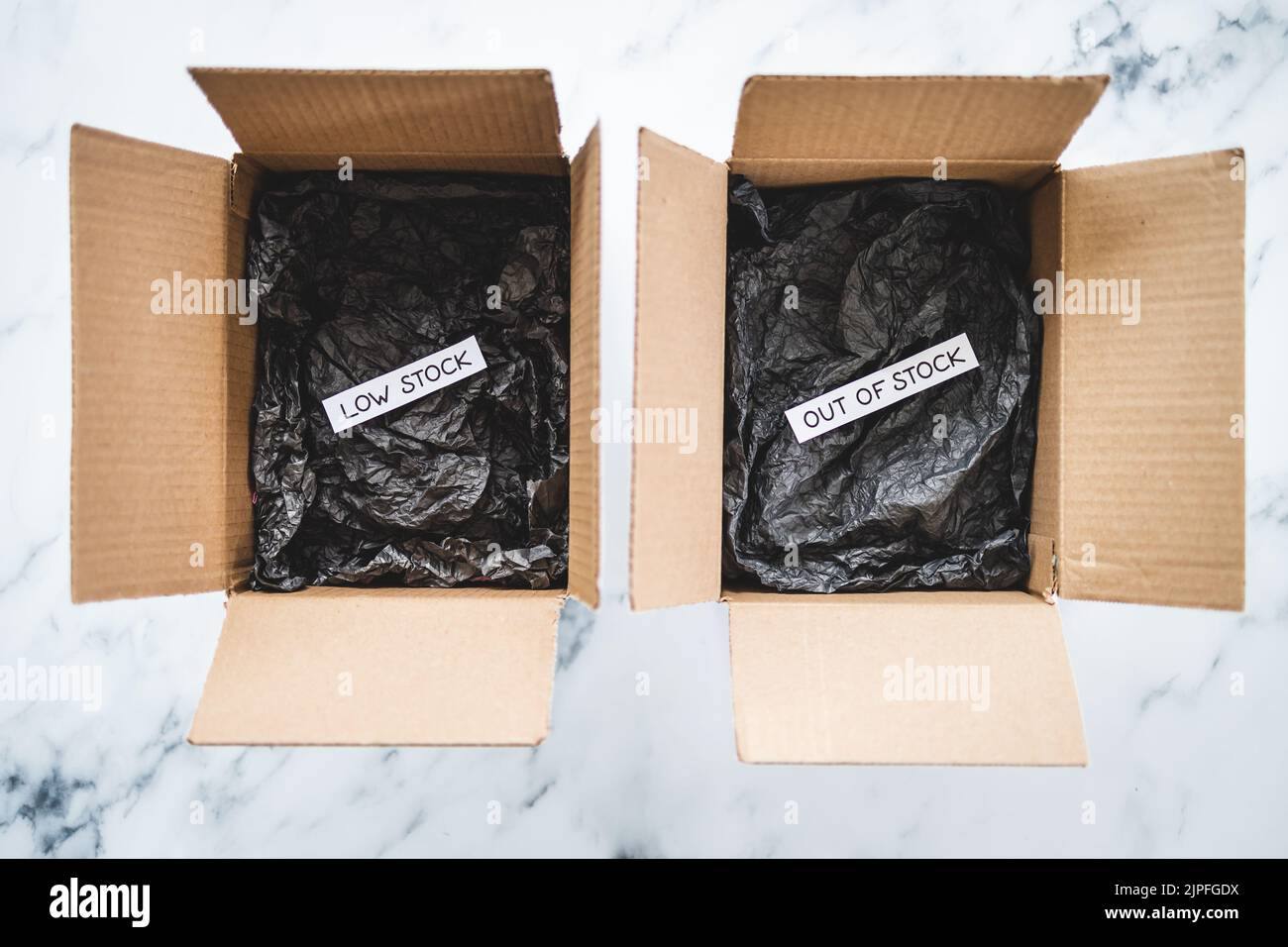 Low stock and out of stock texts inside of empty delivery parcels with ...
