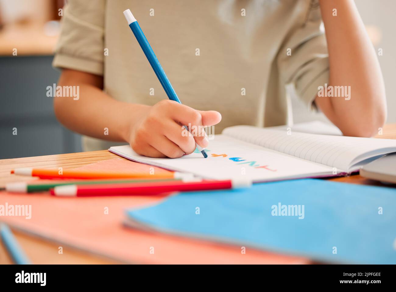 Student drawing picture in book, learning math and doing calculations ...