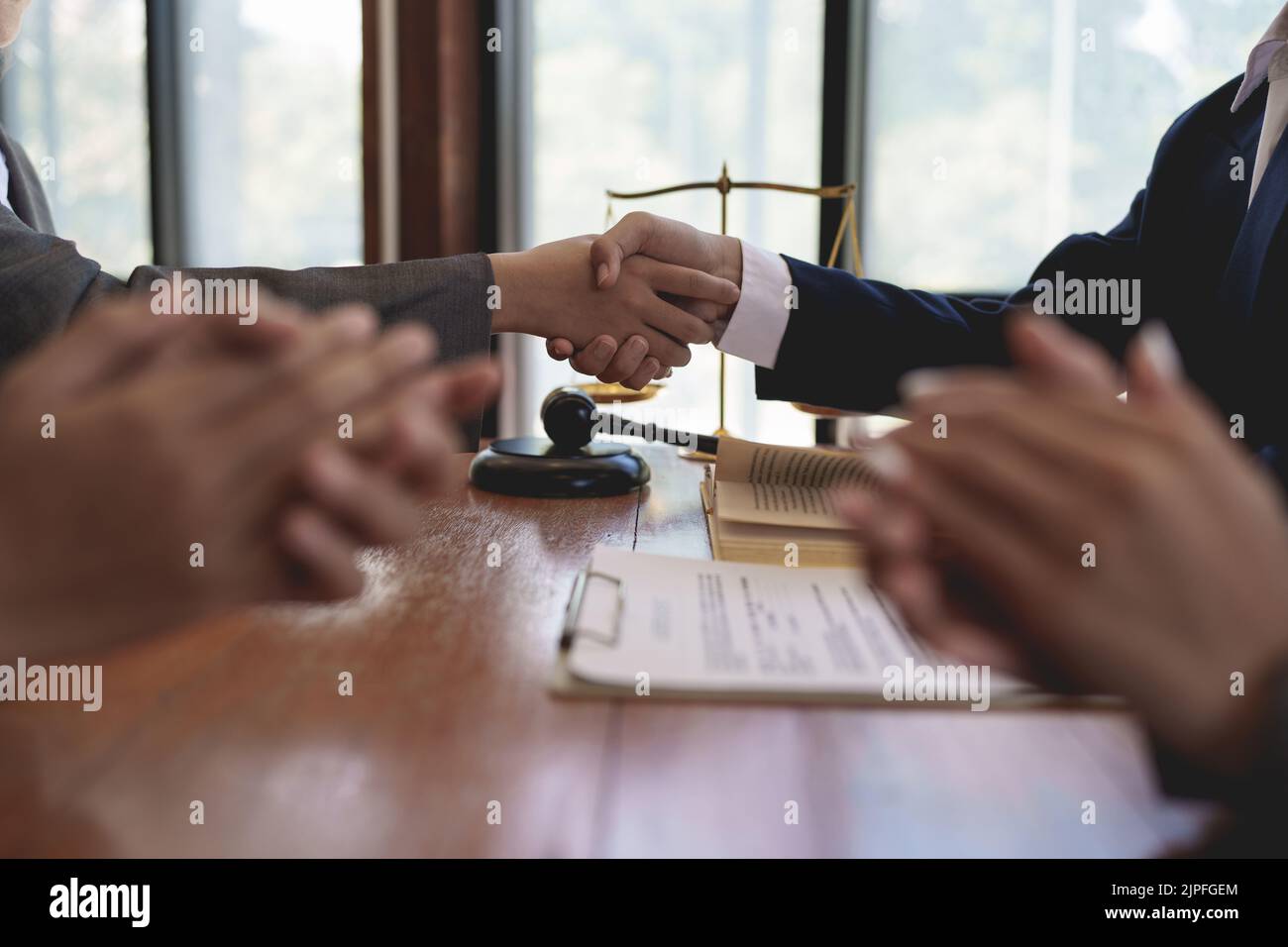 Business team and lawyer shaking hand after discussing about agreement ...