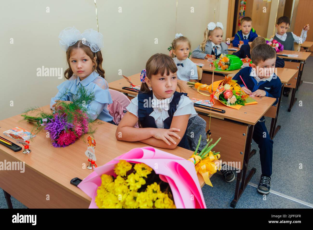 First-grade students and teacher are in school classroom at first ...