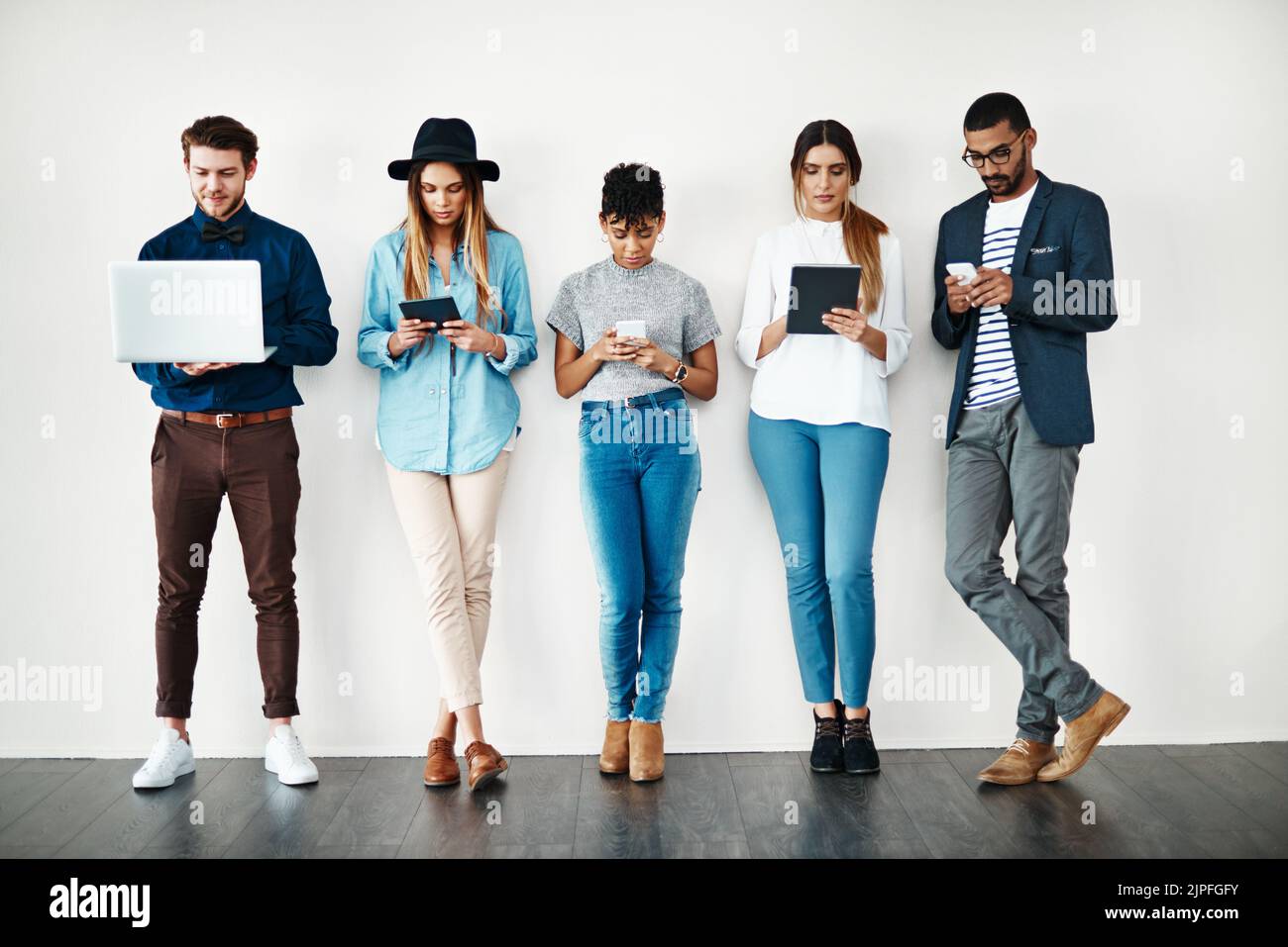 Connected with our device of choice. a group of young people using ...