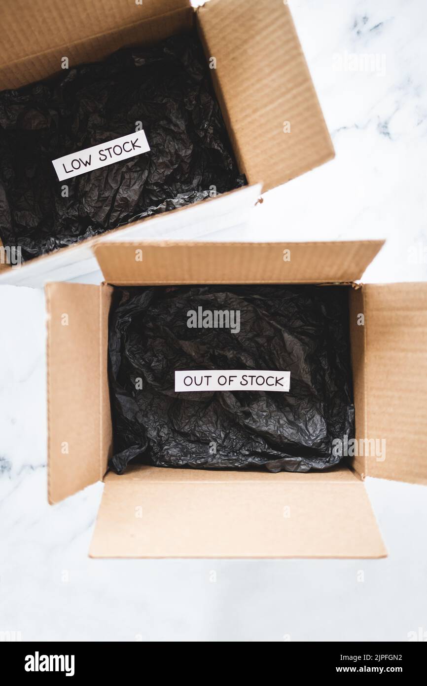 Low stock and out of stock texts inside of empty delivery parcels with ...