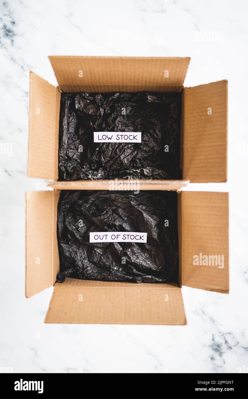 Low stock and out of stock texts inside of empty delivery parcels with ...