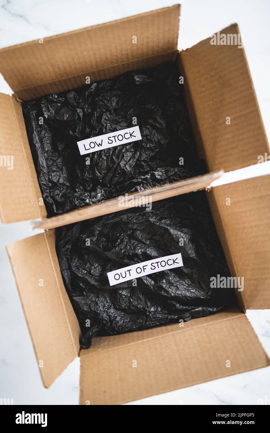 Low stock and out of stock texts inside of empty delivery parcels with ...