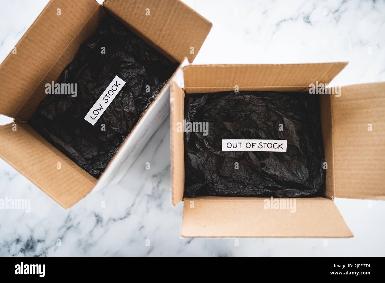 Low stock and out of stock texts inside of empty delivery parcels with ...