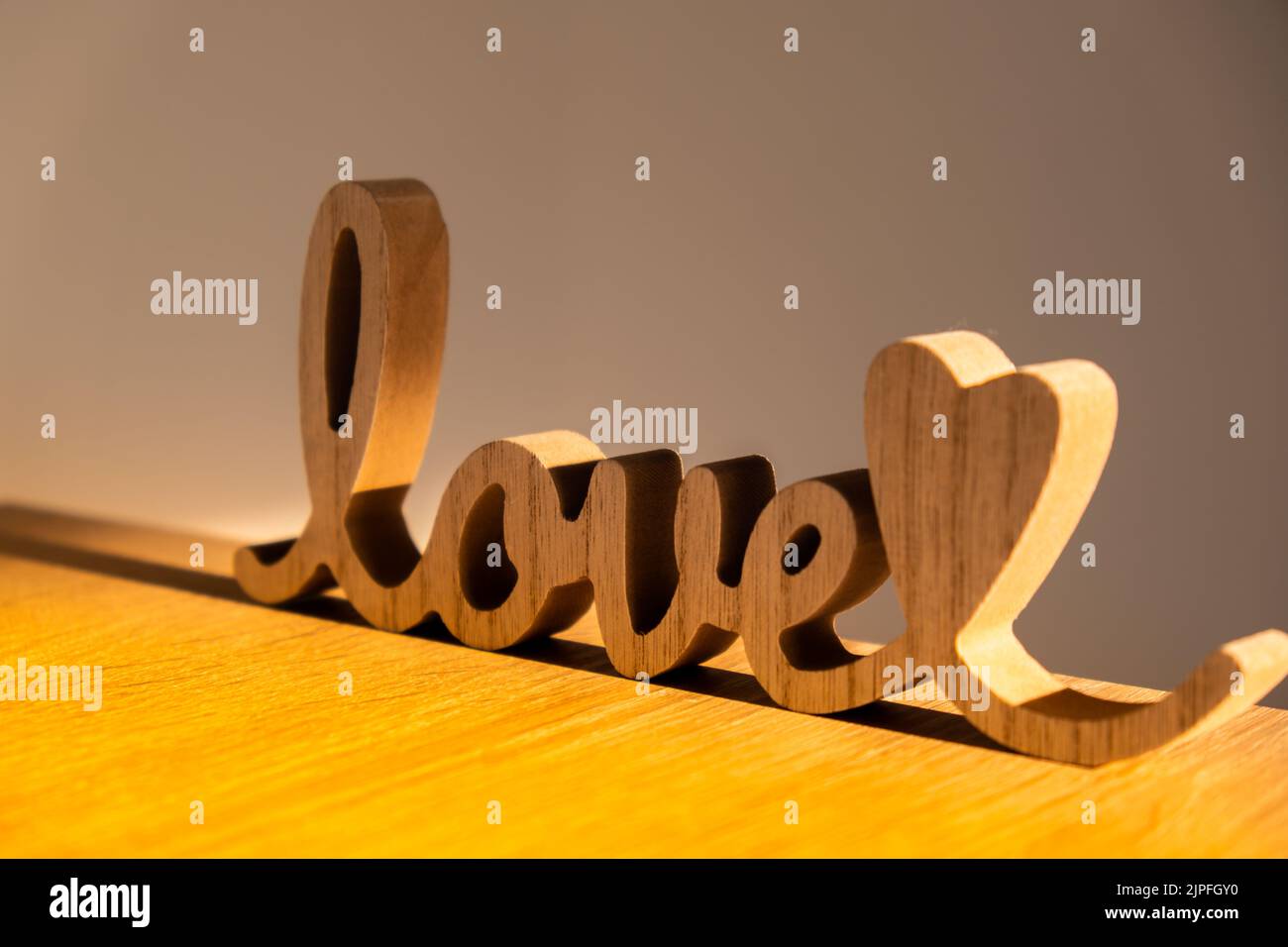 Wooden word love with heart romance. Hard shadows Minimal concept of ...