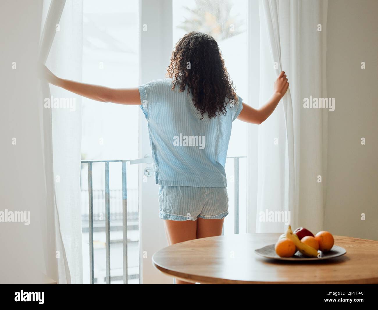 Awake, waking up and fresh new day or morning for a young woman opening ...