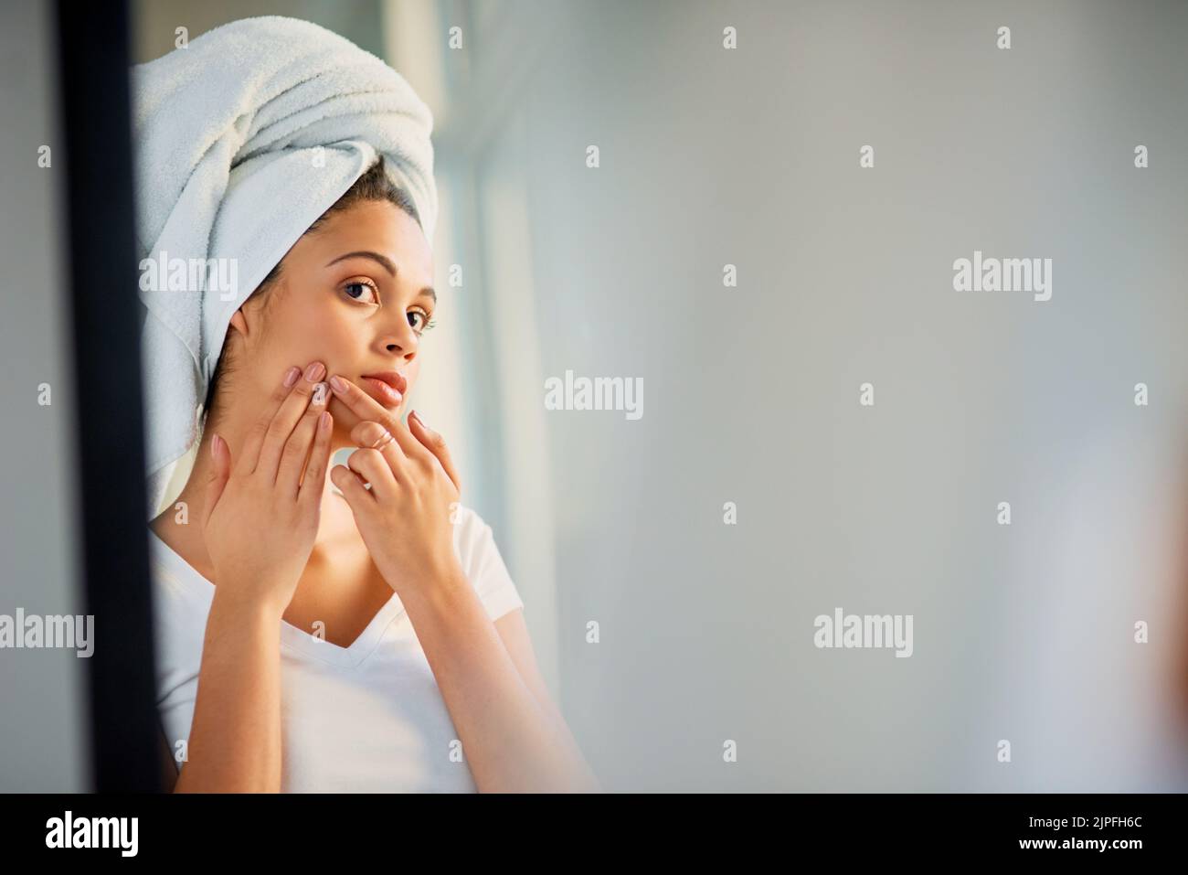 How did this get here. an attractive young woman squeezing a pimple on ...