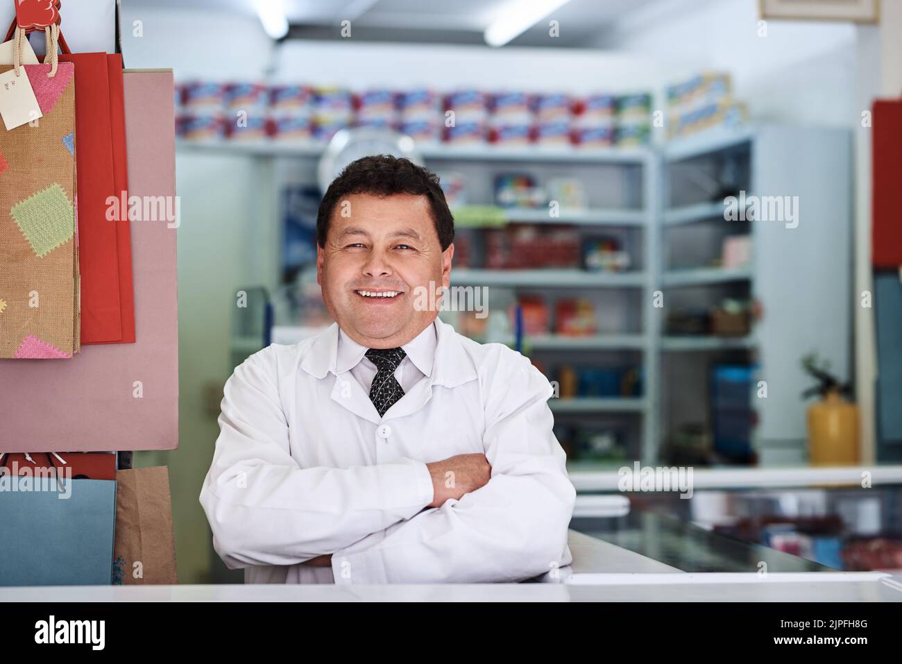 Hes here to improve your health. Portrait of a male pharmacist in a ...