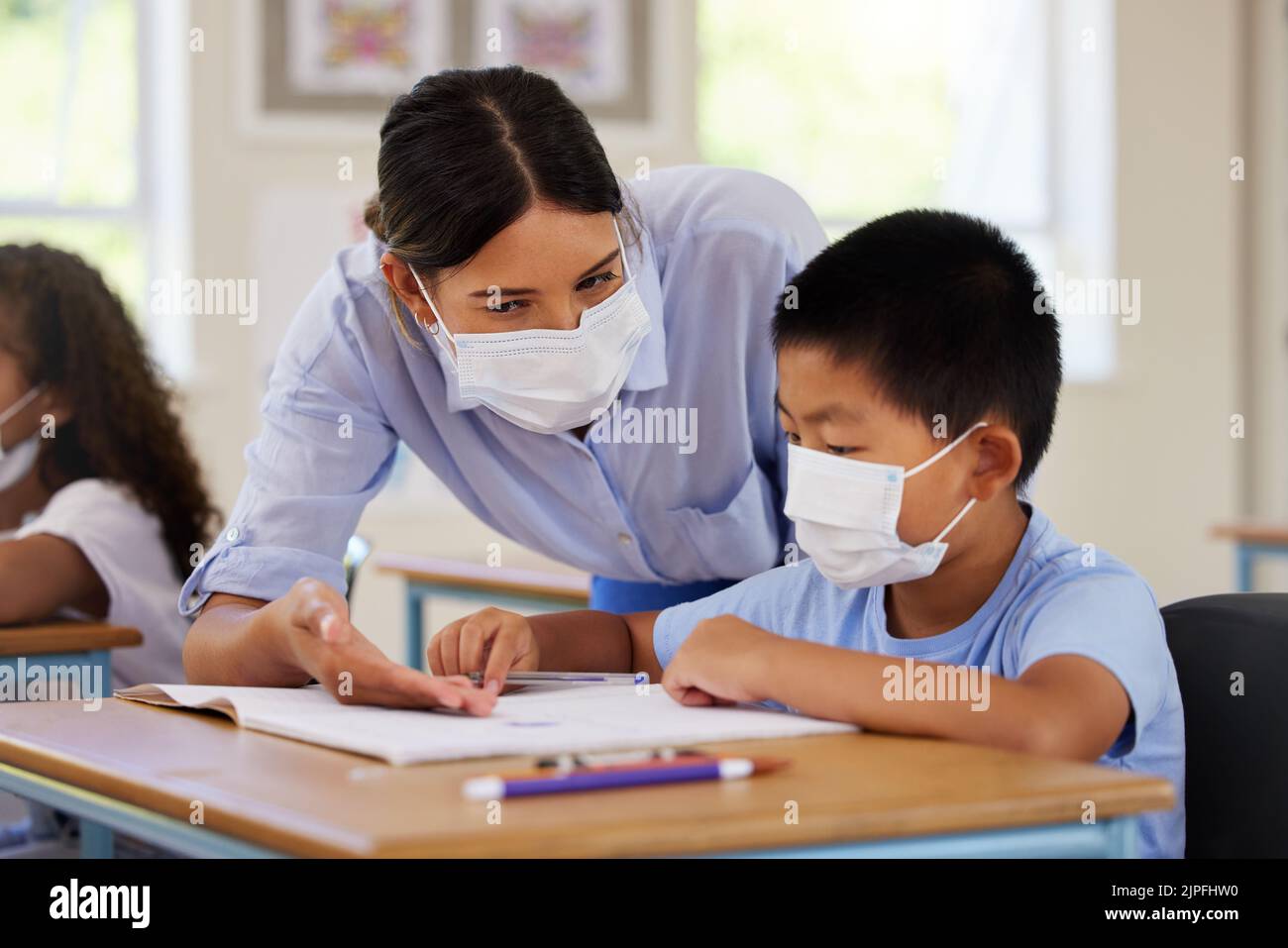 Covid, students and education teacher helping learning children in ...