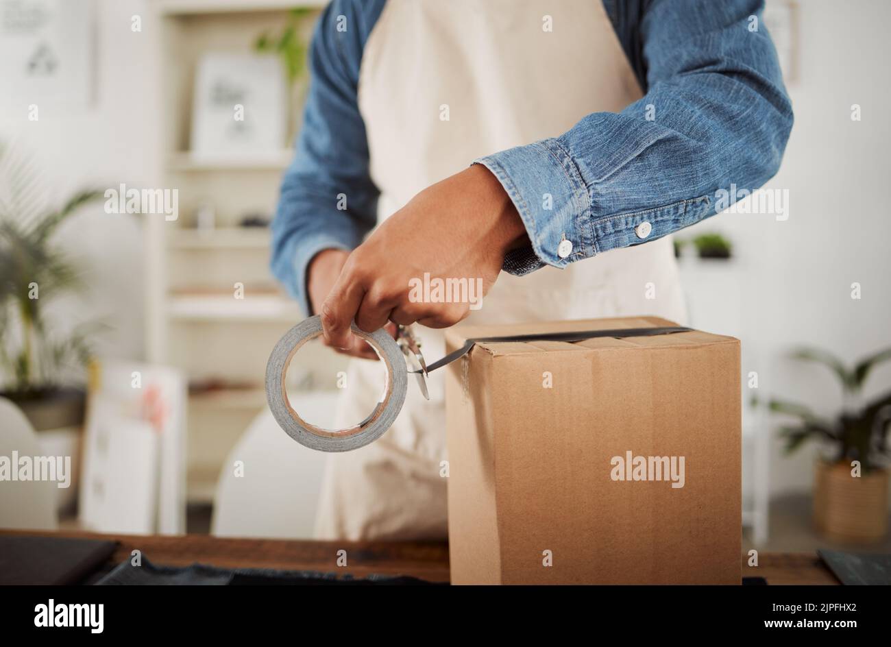 Packing, packaging and boxing product by wrapping in sellotape or duct ...