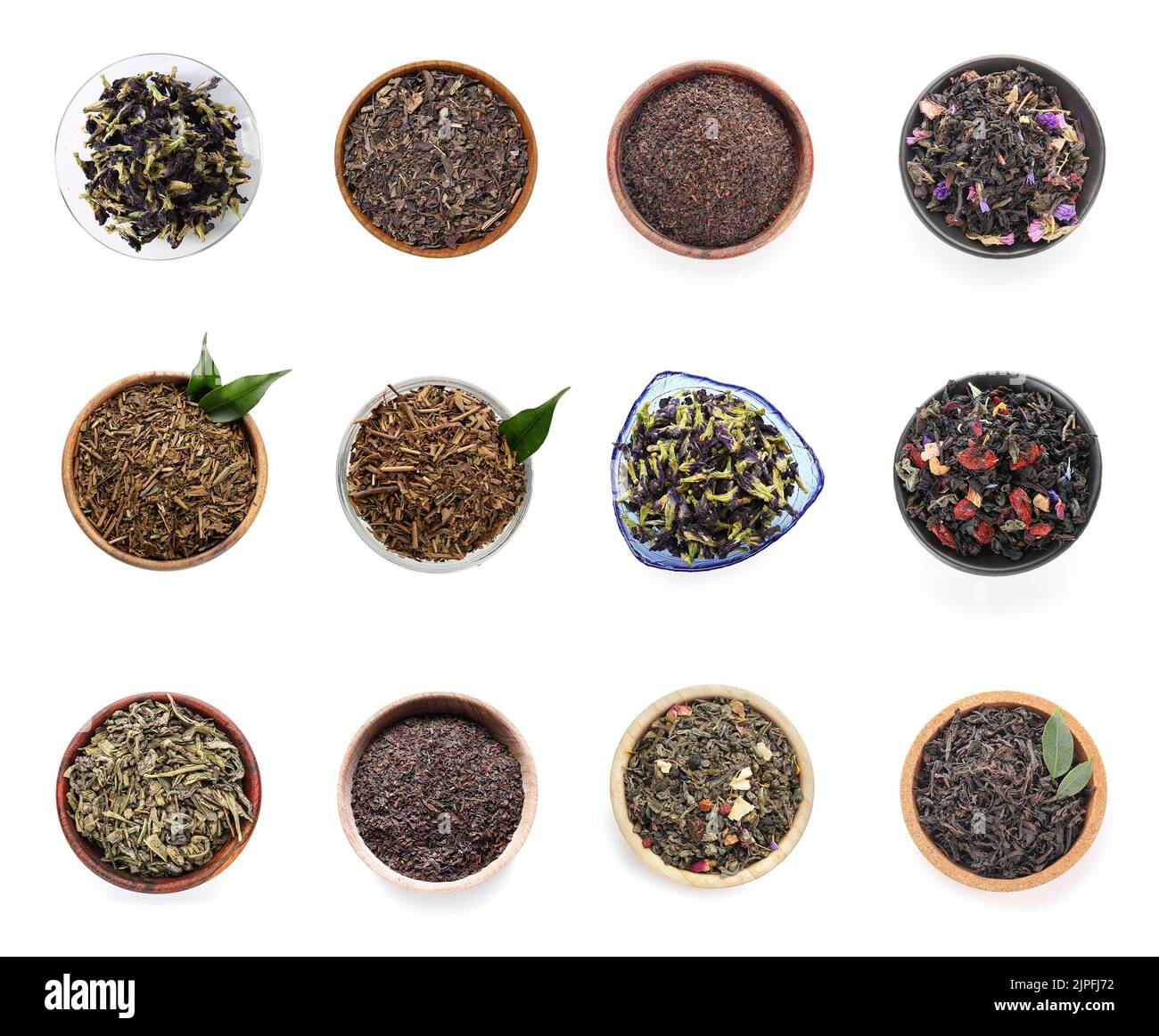 Bowls with different types of dry tea on white background, top view ...