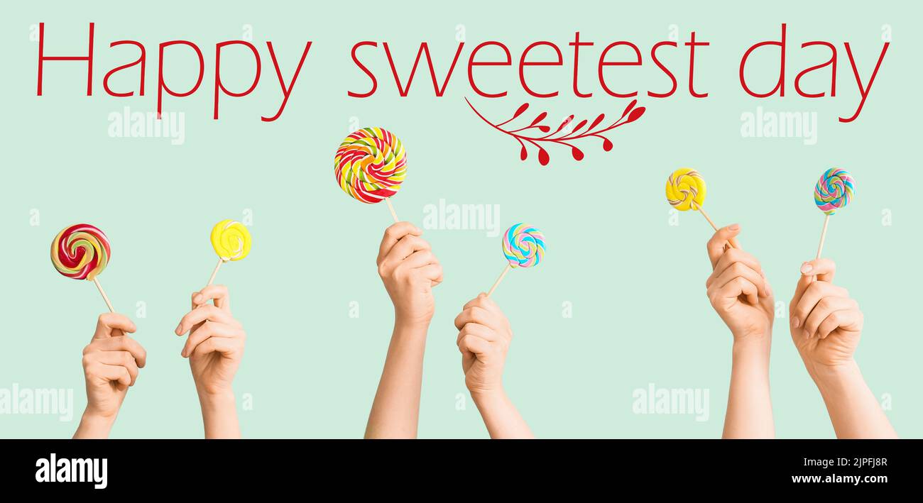 Hands with sweet lollipops on color background. Happy Sweetest Day ...