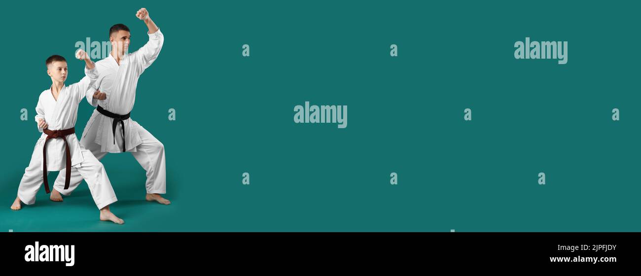 Boy practicing karate with instructor on green background. Banner for ...