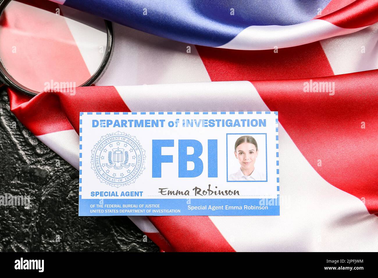 Flag of USA, document of FBI agent and magnifier on dark background ...
