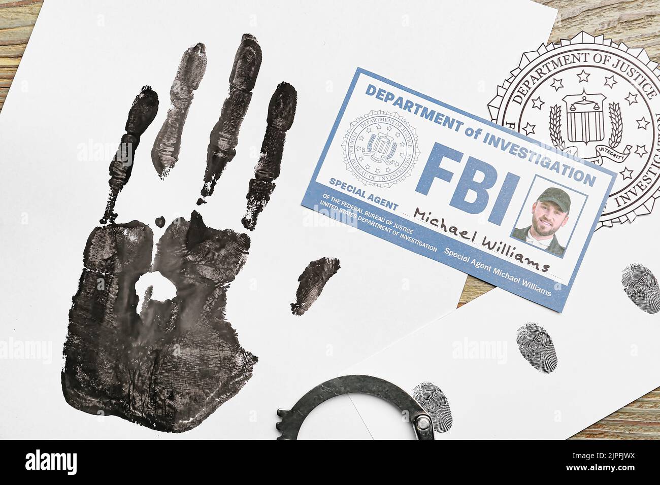 Paper sheets with different prints and document of FBI agent on table ...