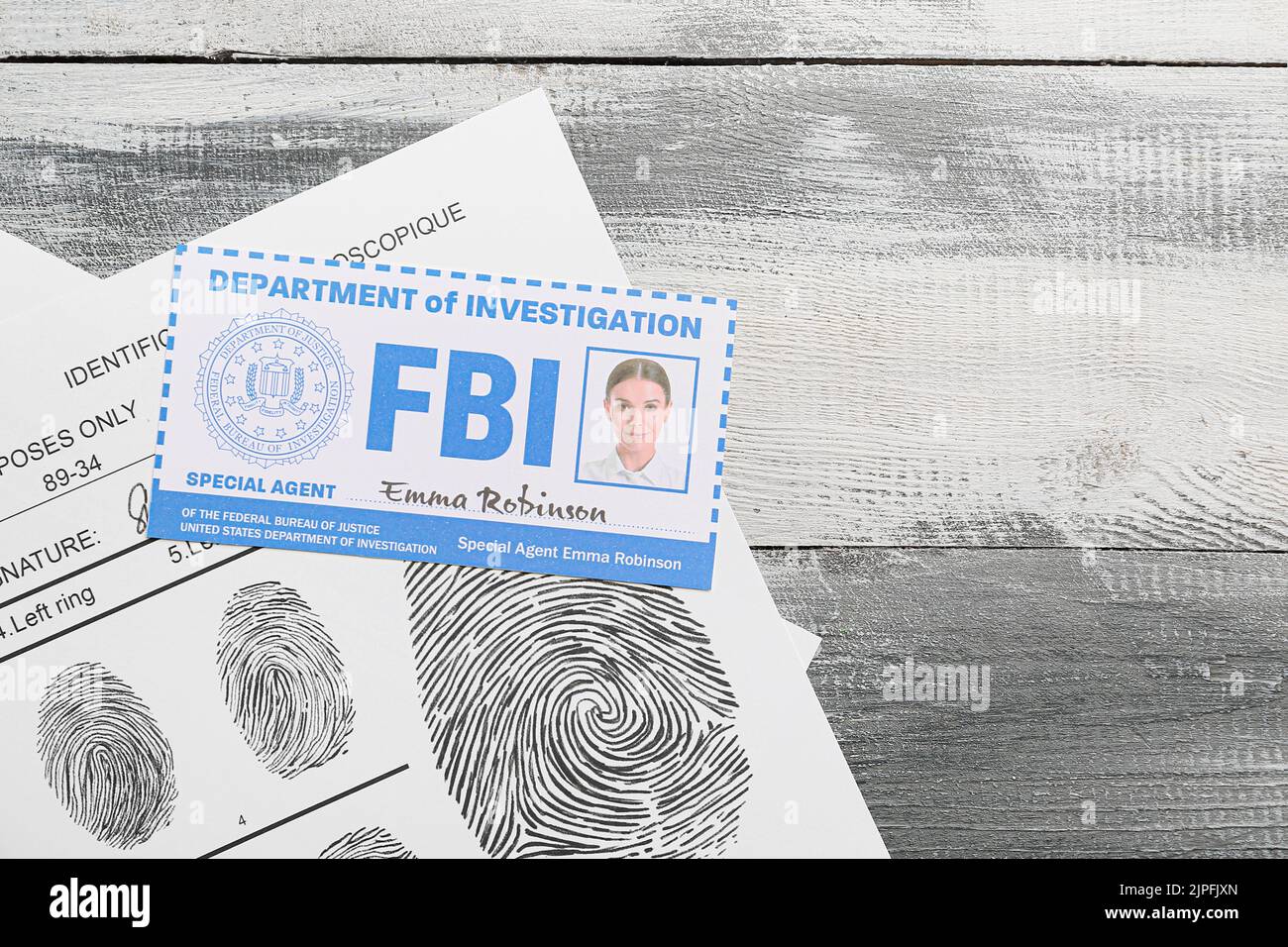 Document of FBI agent and paper sheets with finger prints on wooden ...