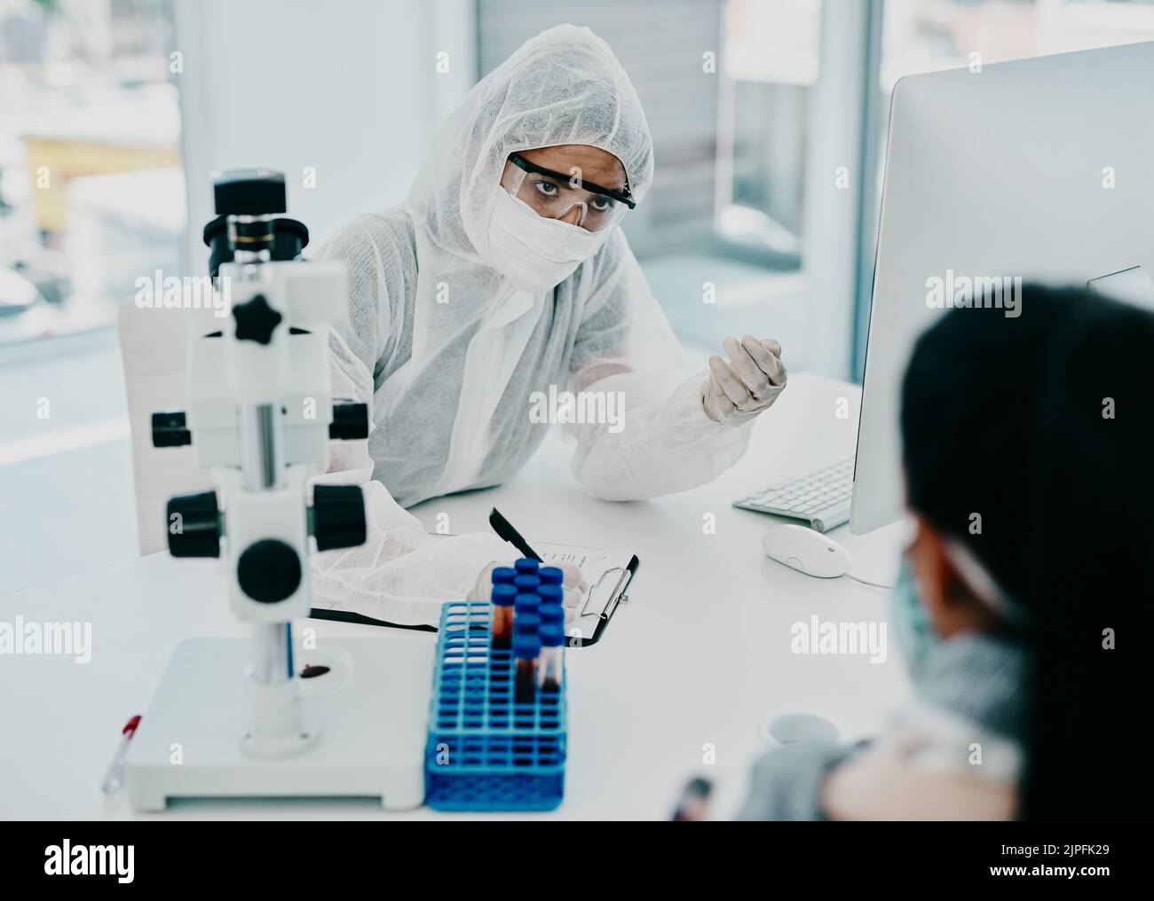 Covid and disease healthcare worker wearing hazmat suits in a ...