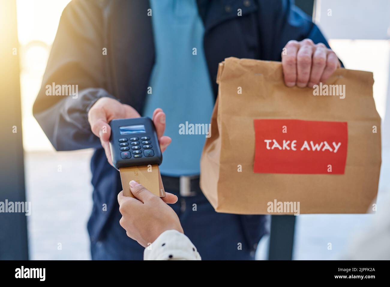 Your food has arrived. an unrecognizable delivery man receiving payment ...