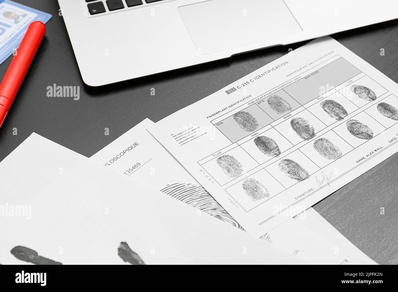 Paper sheets with different prints and laptop at workplace of FBI agent ...