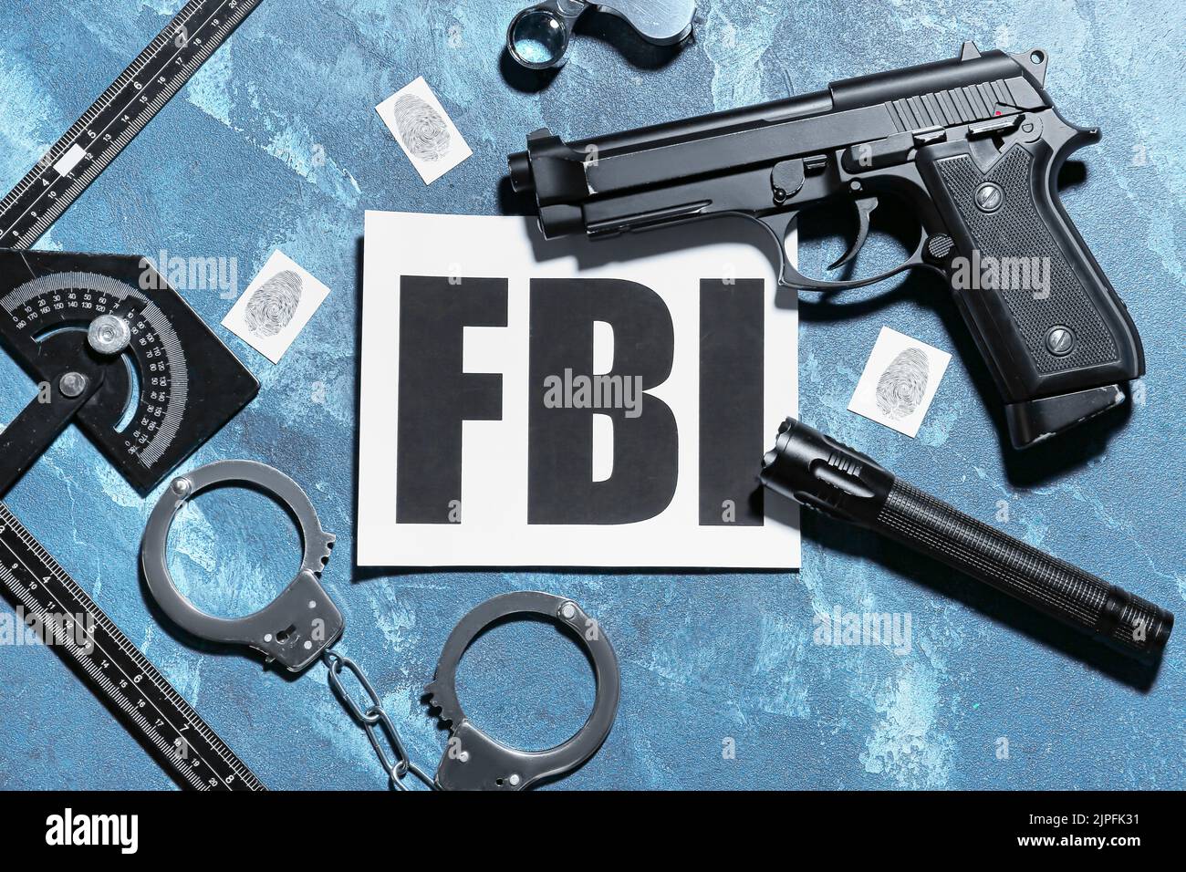 Paper sheet with abbreviation FBI and accessories of agent on color ...