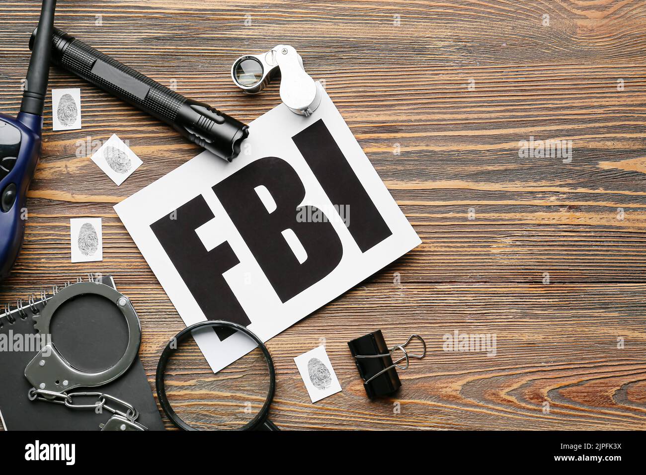 Paper sheet with abbreviation FBI and accessories of agent on wooden ...