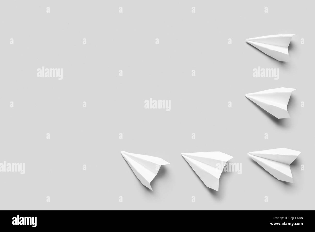 Paper planes on grey background Stock Photo - Alamy