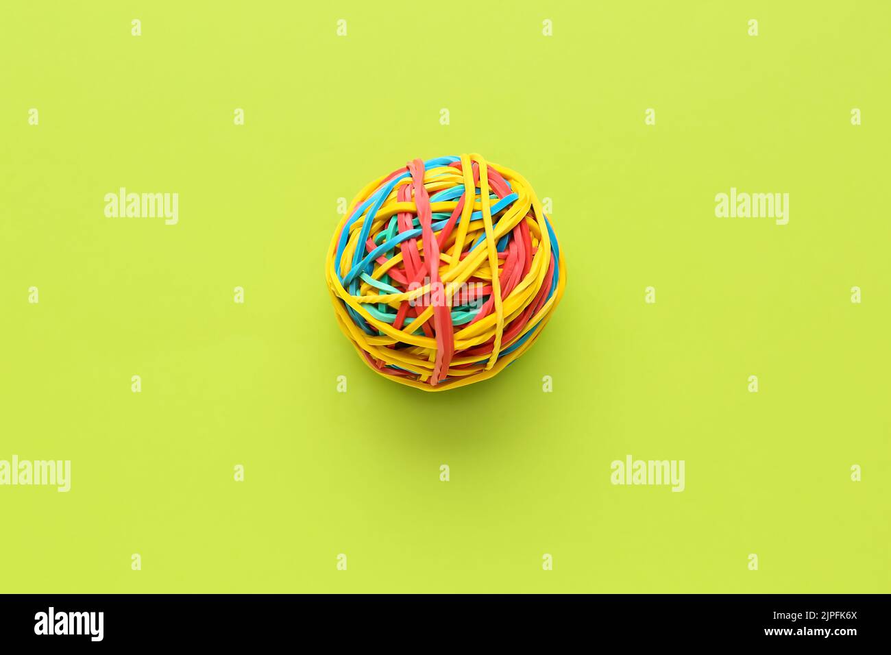 Colorful rubber band ball on green background Stock Photo - Alamy