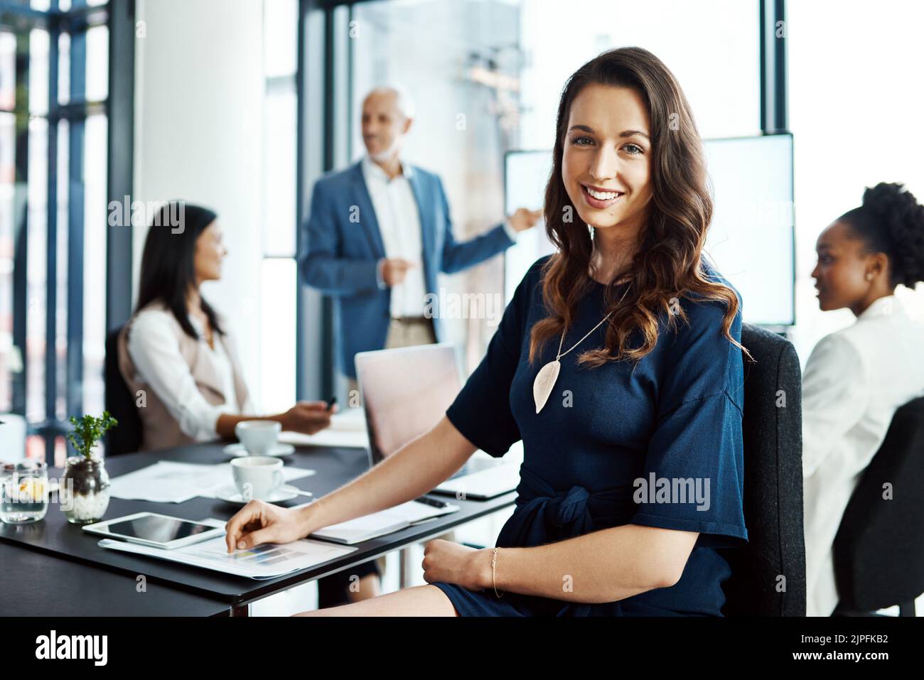 Corporate manager feeling positive about the leadership in a meeting ...