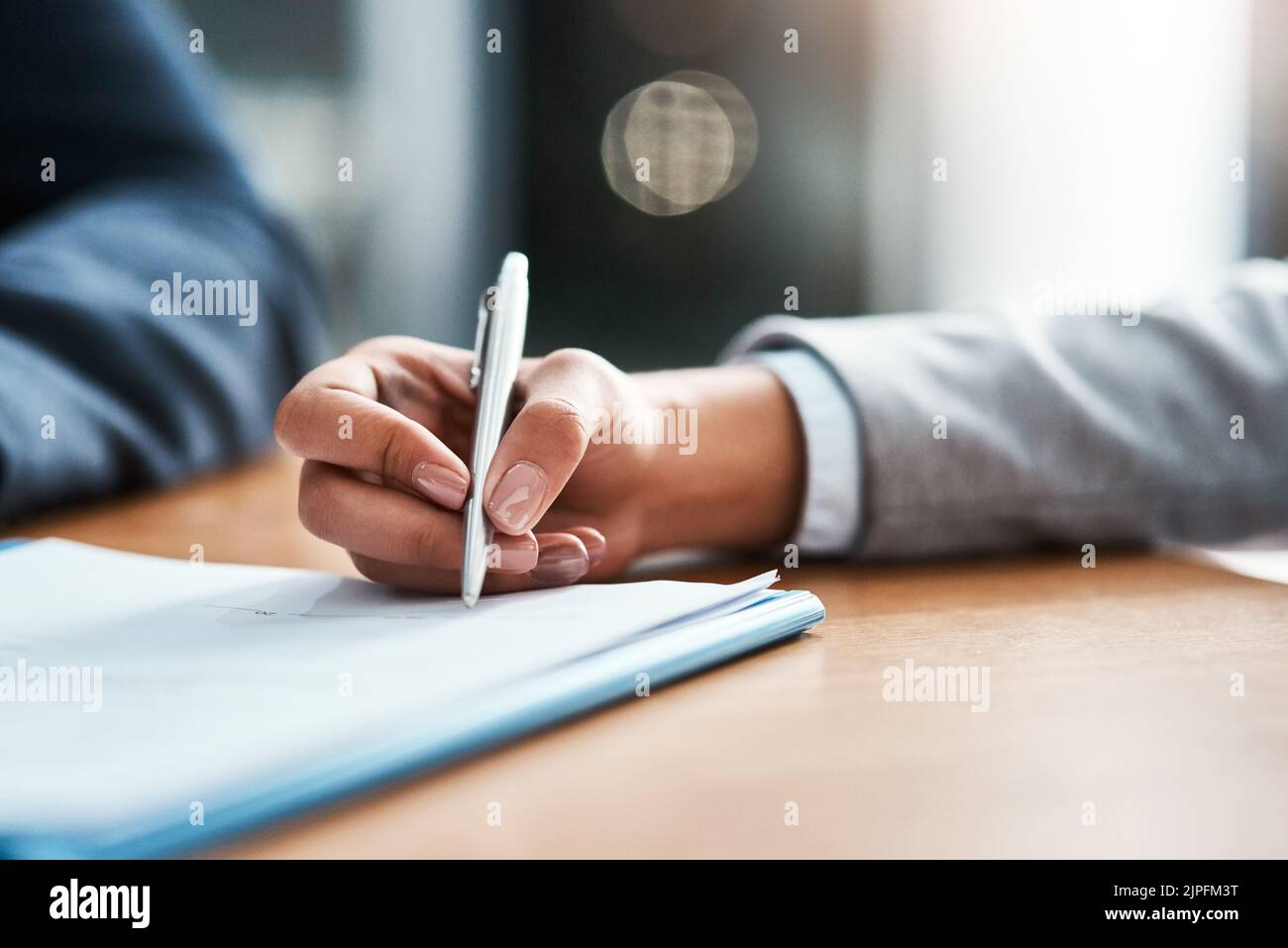 Marking each sheet with a signature. Closeup shot of two unrecognizable ...