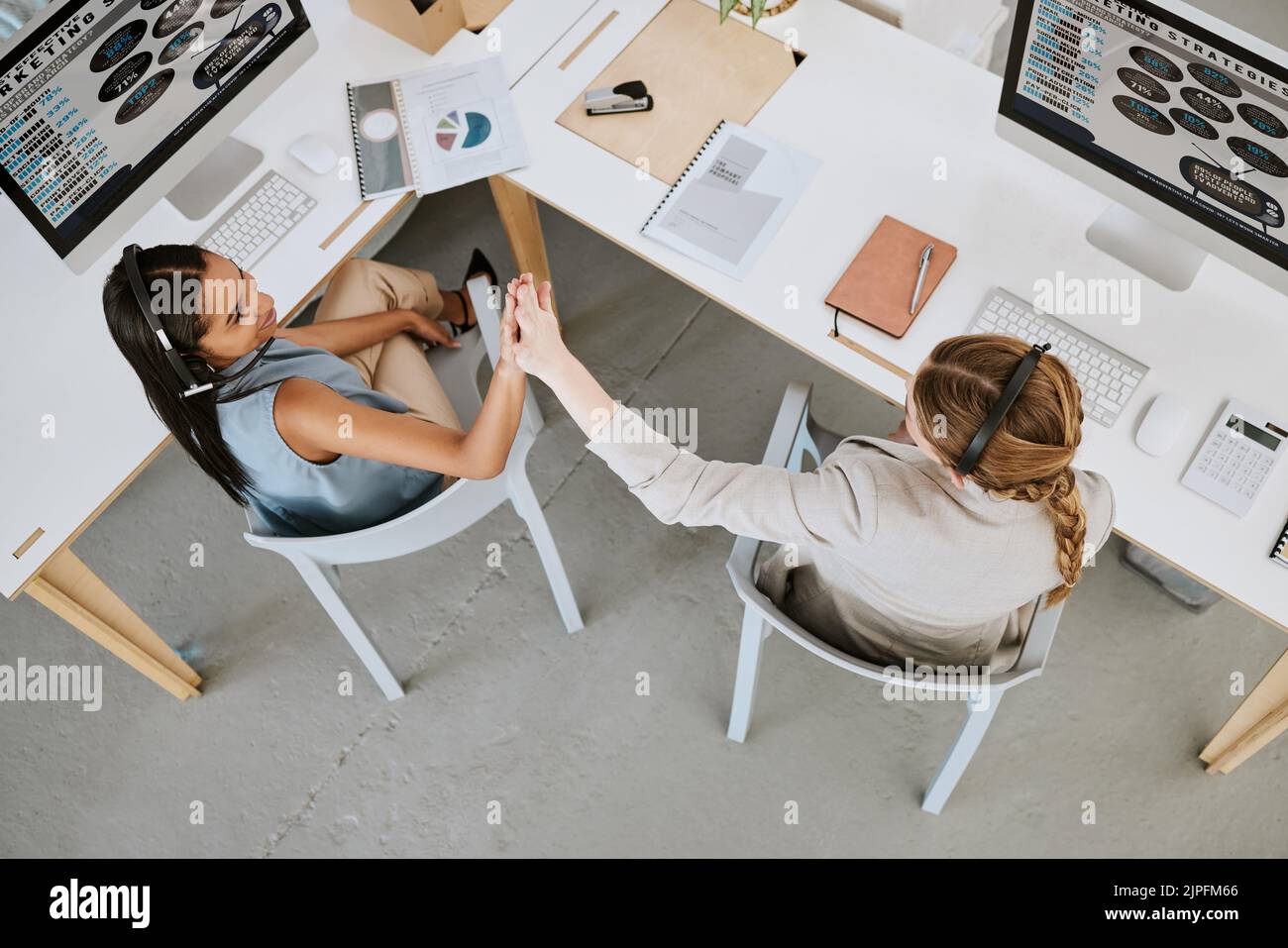 Teamwork, high five between call center colleagues while celebrating a ...