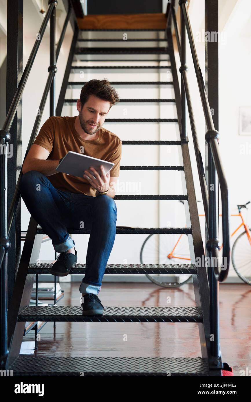 Using the internet to spark new ideas. a young designer working on his ...