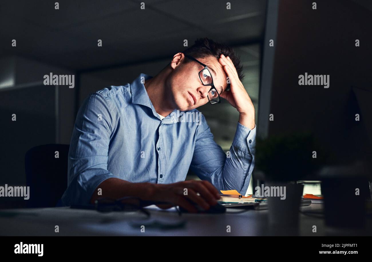 Tired, stressed businessman suffering from headache, working late night ...