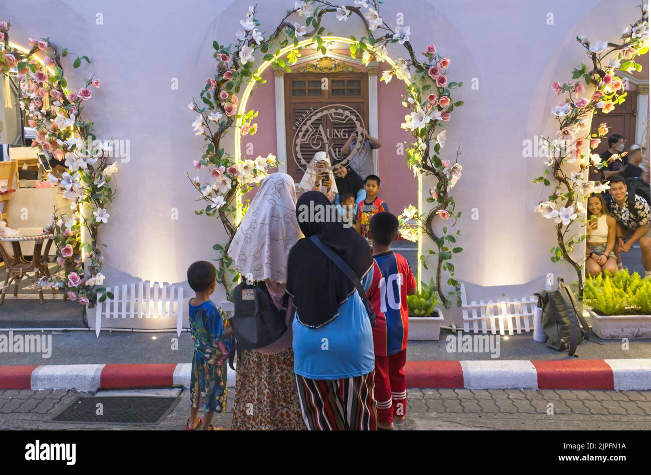 Malaysian tourists pose for selfies at a one-way mirror window of Aung ...