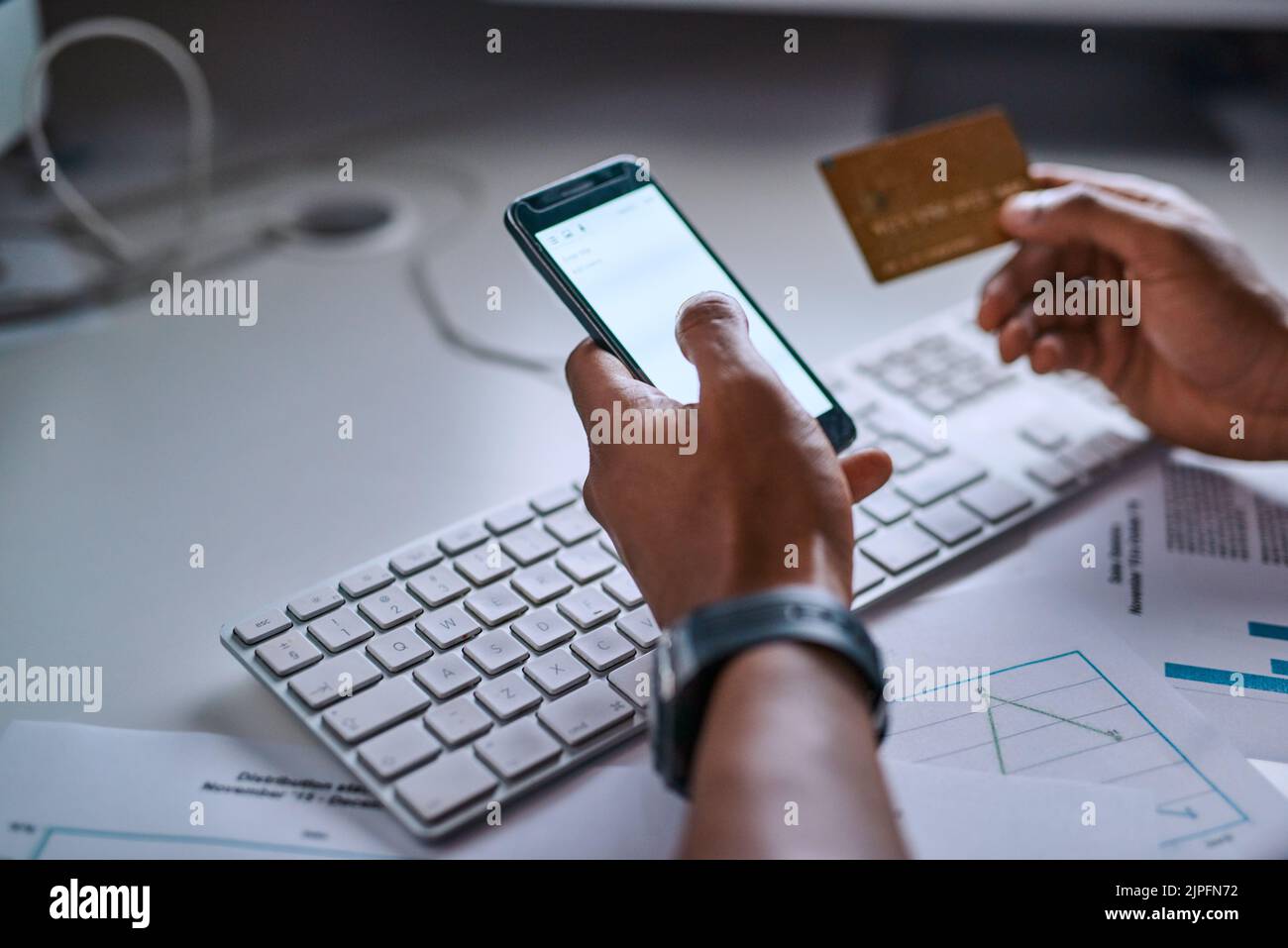 Paying accounts on the go. High angle shot of an unrecognizable man ...