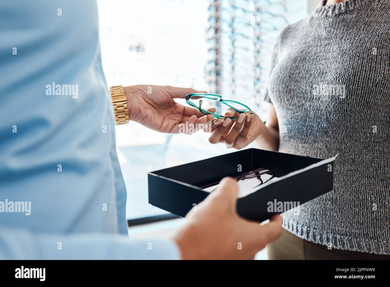 Vision, sight and treatment by an optometrist giving a woman a pair of ...